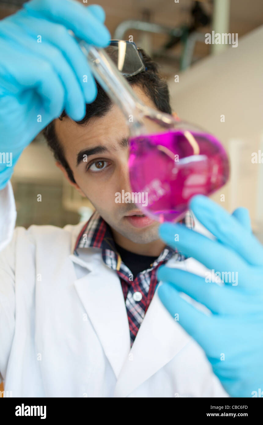 Young scientist observing liquid hi-res stock photography and images ...