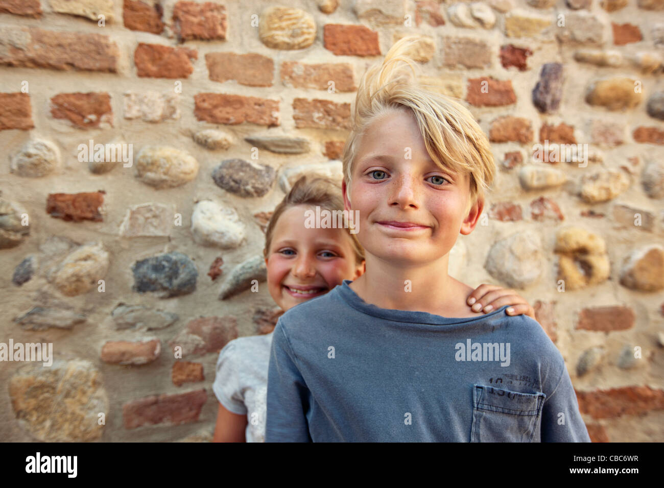 Siblings smiling together outdoors Stock Photo - Alamy
