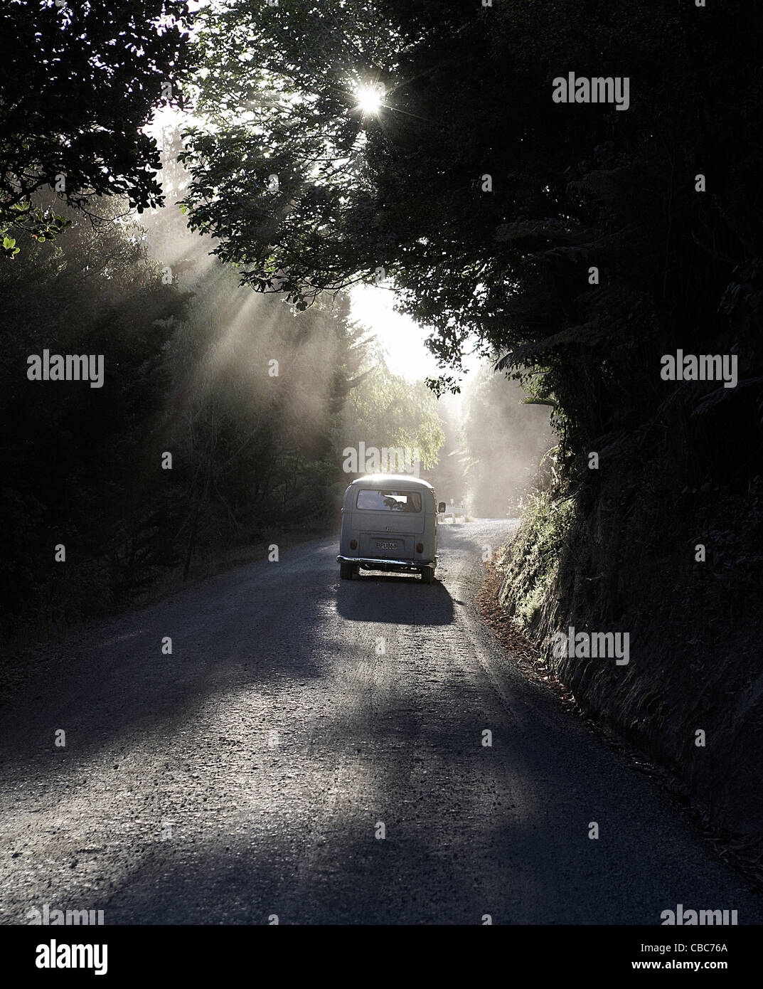 Car driving down rural road Stock Photo - Alamy