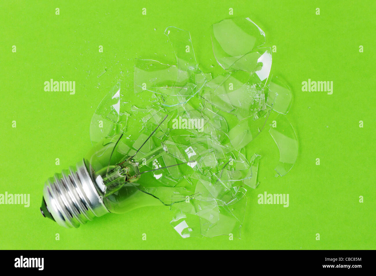 The brokenbulb. Glass splinters on a green background Stock Photo - Alamy