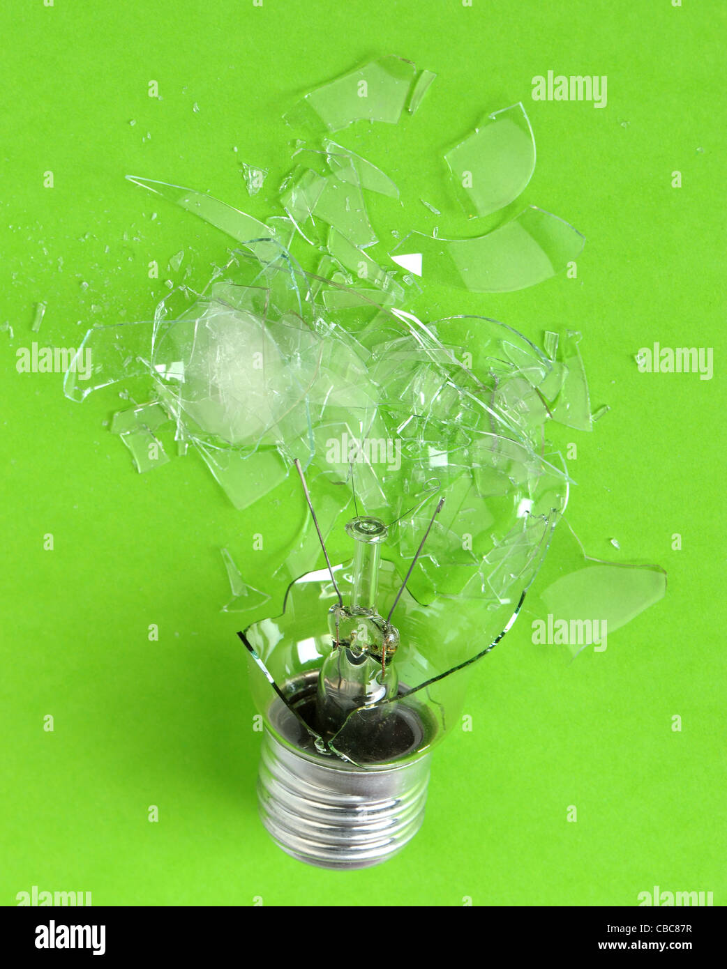 The broken bulb. Glass splinters on a green background Stock Photo - Alamy