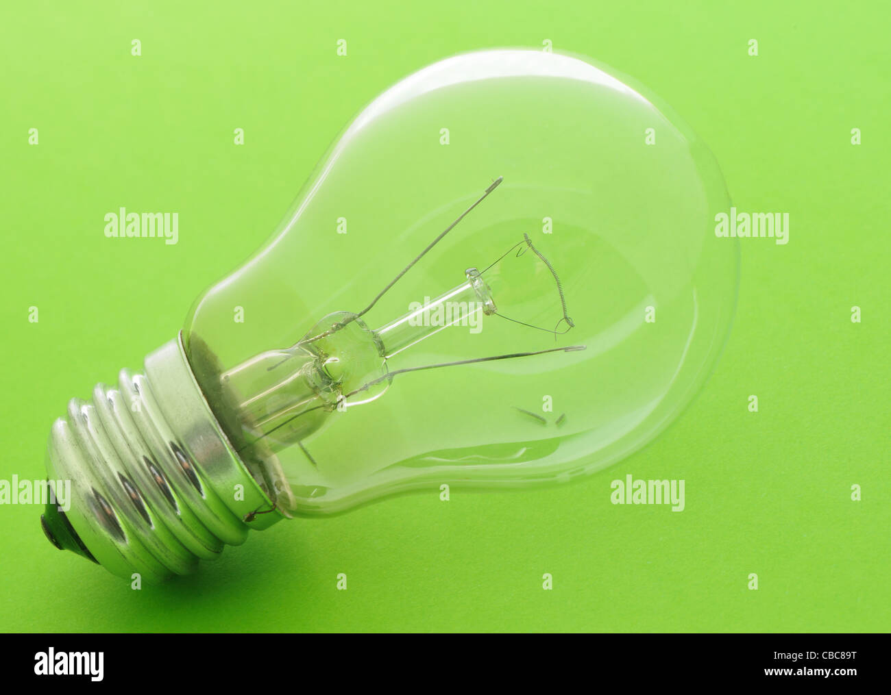 faulty a bulb. The lamp lies on a green background Stock Photo - Alamy