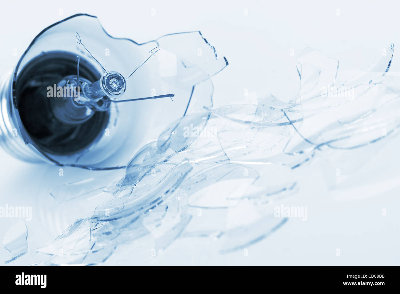 The broken bulb. Glass splinters, blue toning Stock Photo - Alamy