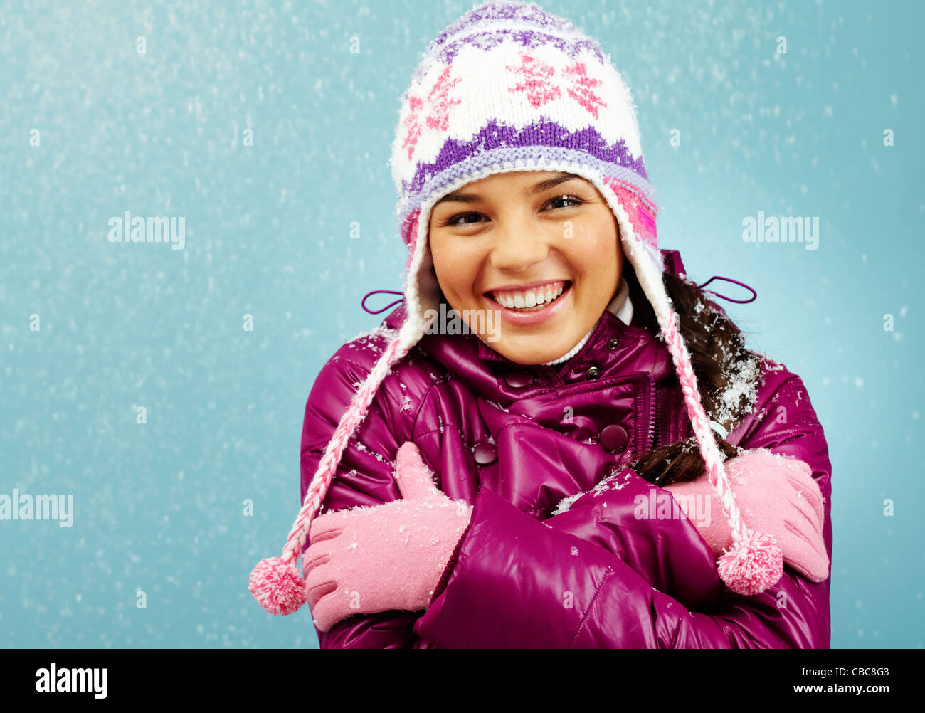 Smiling girl looking at camera showing how cold she is Stock Photo - Alamy
