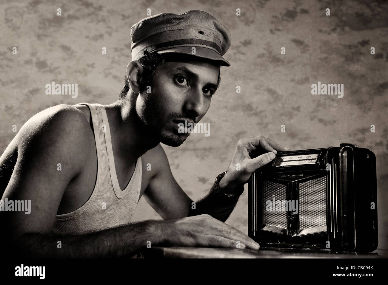 Revolutionary man listens to an old style radio Stock Photo - Alamy