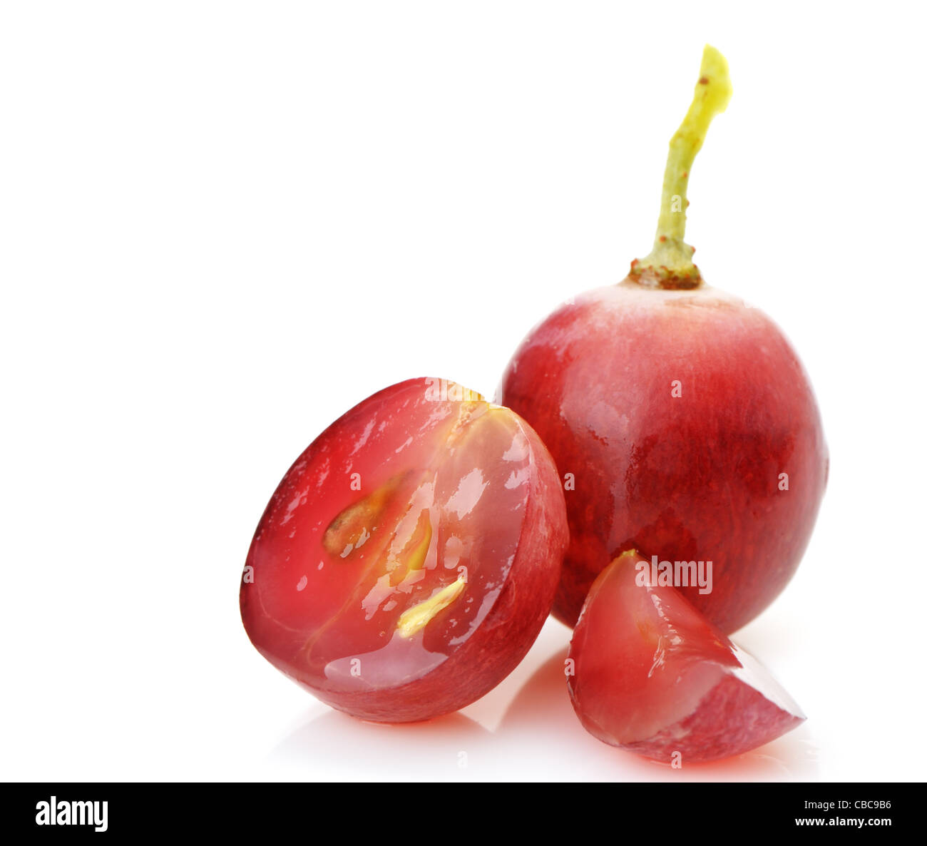 red grapes. Cut on segments grapes berry. It is isolated on a white ...