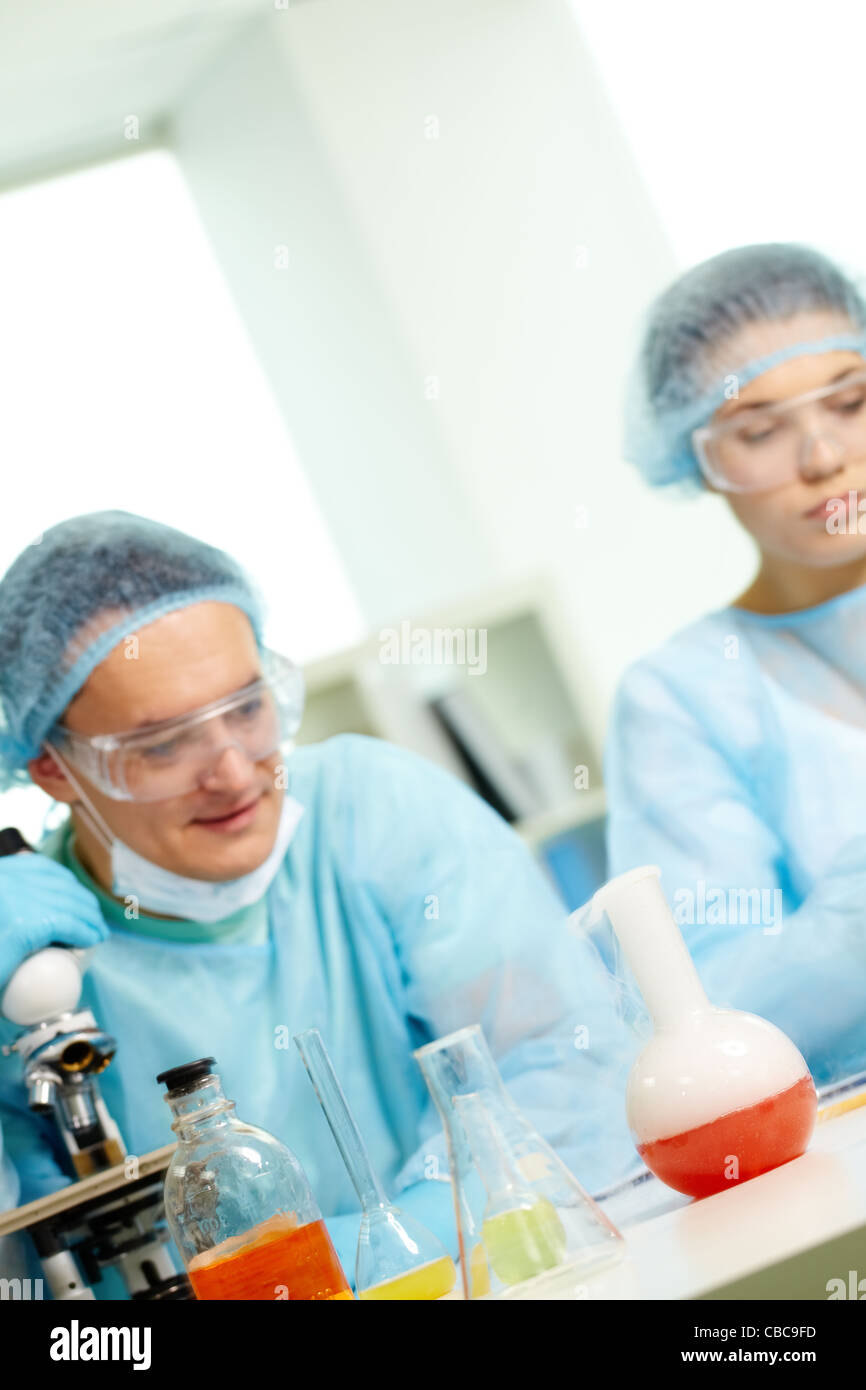 Biochemistry man woman lab bottles hi-res stock photography and images ...