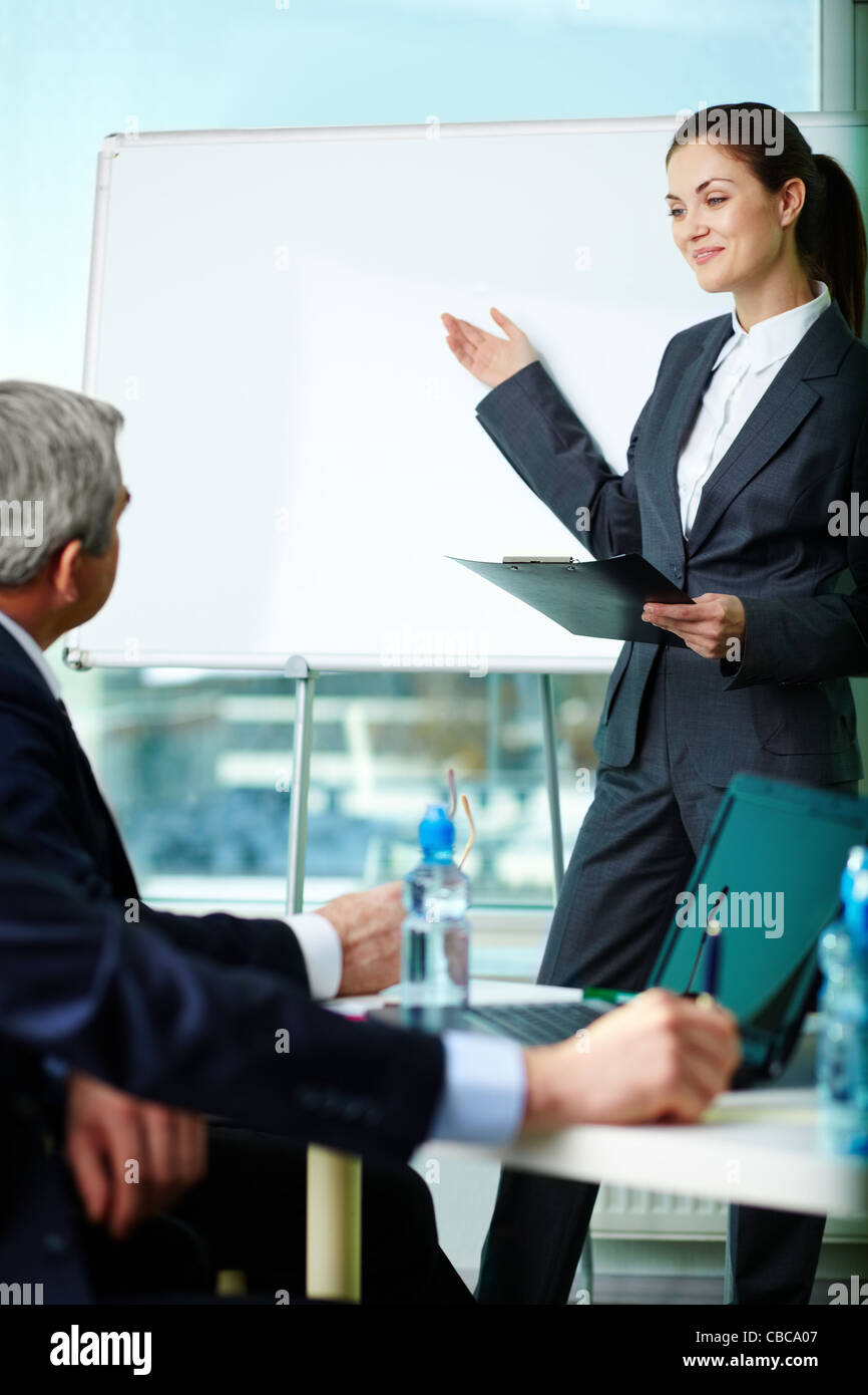 Portrait of successful female presenting her project at seminar or ...