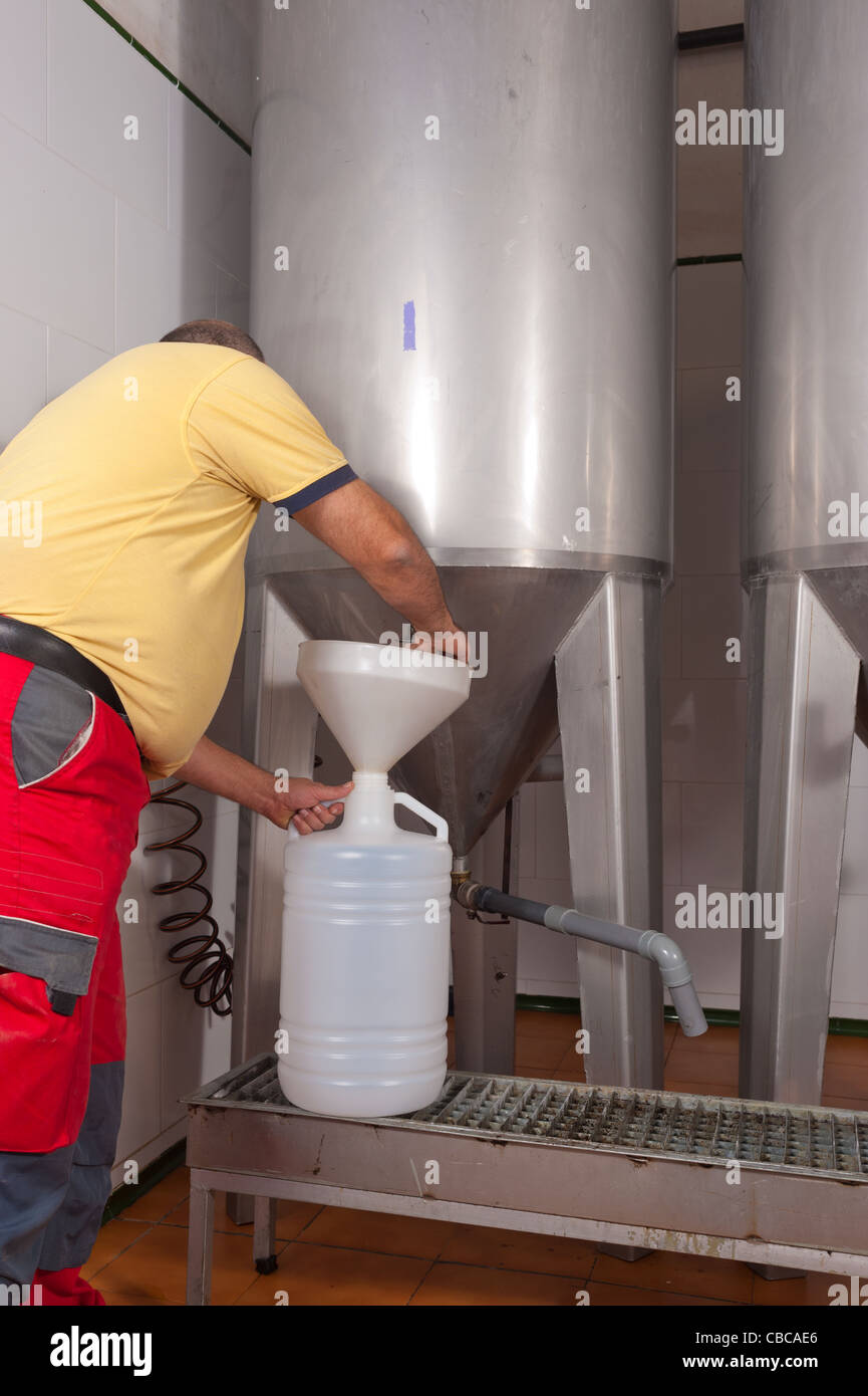 Farmer collecting the freshly pressed oil from his olive crop Stock ...