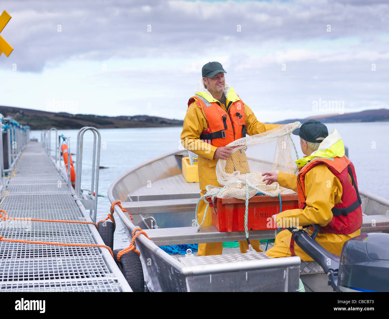 Three fishermen talking hi-res stock photography and images - Alamy