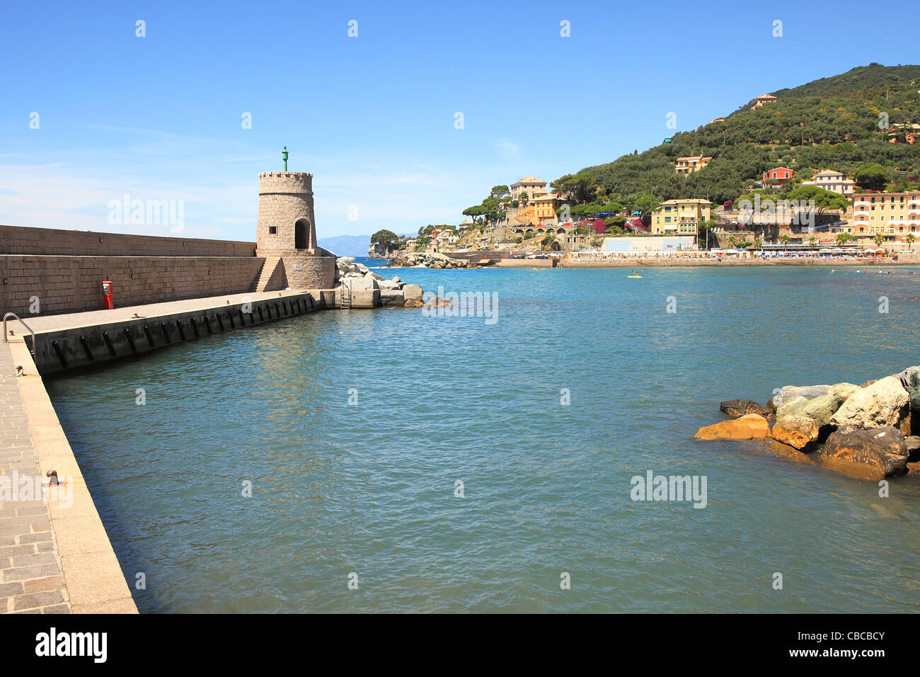 Stone pier with ancient tower and Recco shoreline in Liguria, northern ...