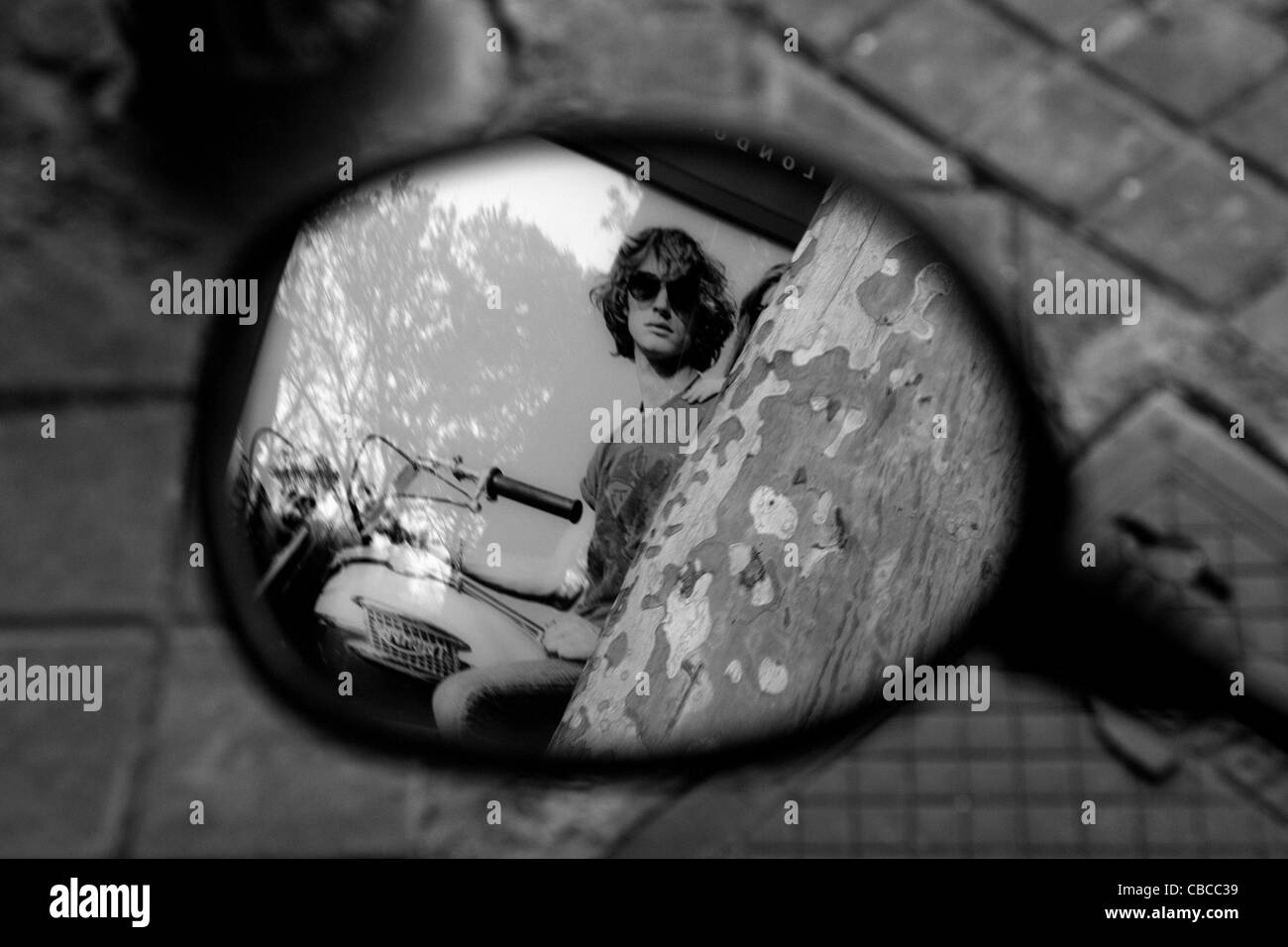 reflection of a poster is a vespa mirror Stock Photo - Alamy