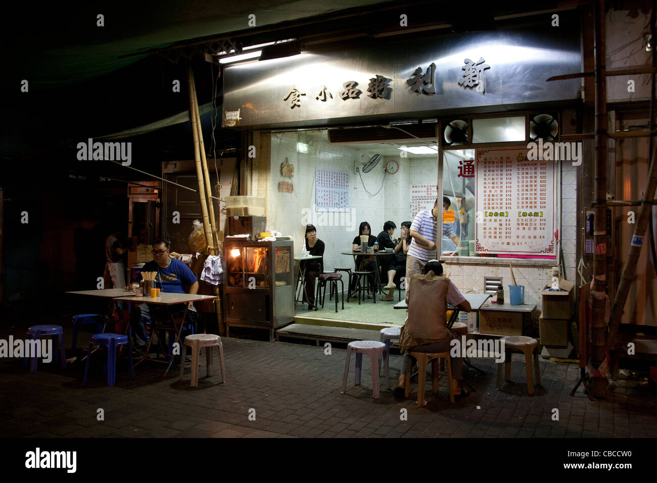 People eating at outside tables at night in the street cafes of Temple ...