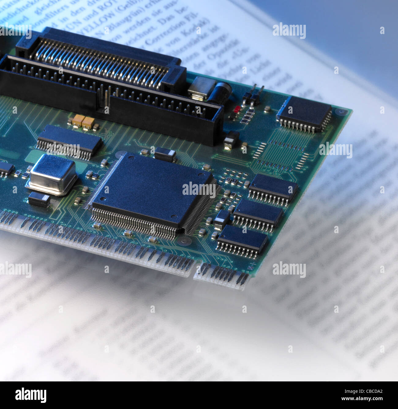 studio shot of a computer plug in card on printed book page Stock Photo ...