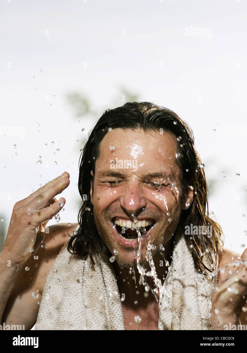 Man splashing his face with water Stock Photo - Alamy