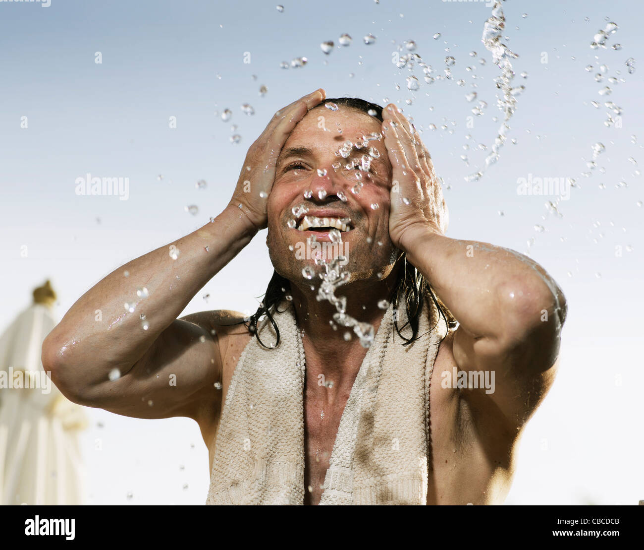 Man splashing his face with water Stock Photo - Alamy