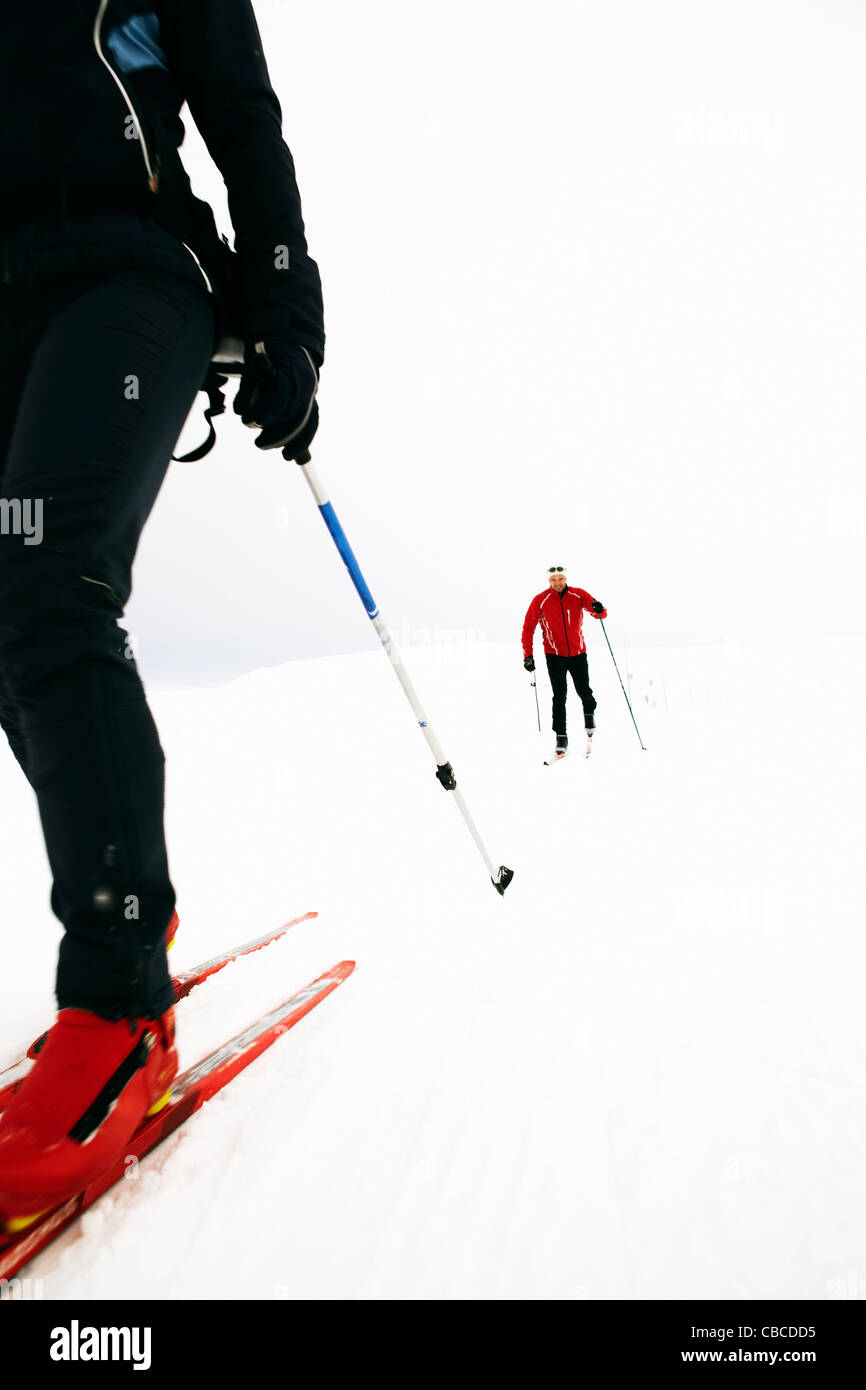 Couple cross-country skiing in snow Stock Photo - Alamy