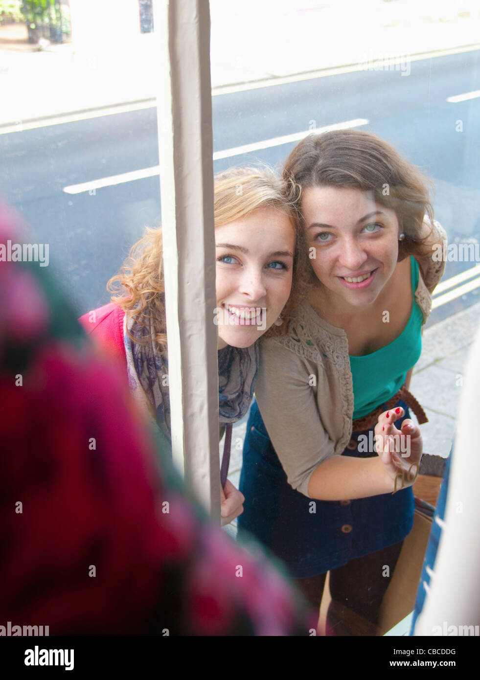 Teenage girls window shopping together Stock Photo - Alamy