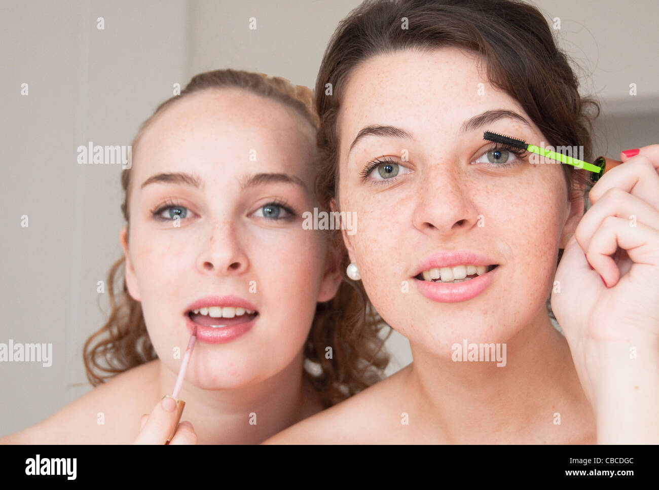 Teenage girls applying makeup Stock Photo - Alamy