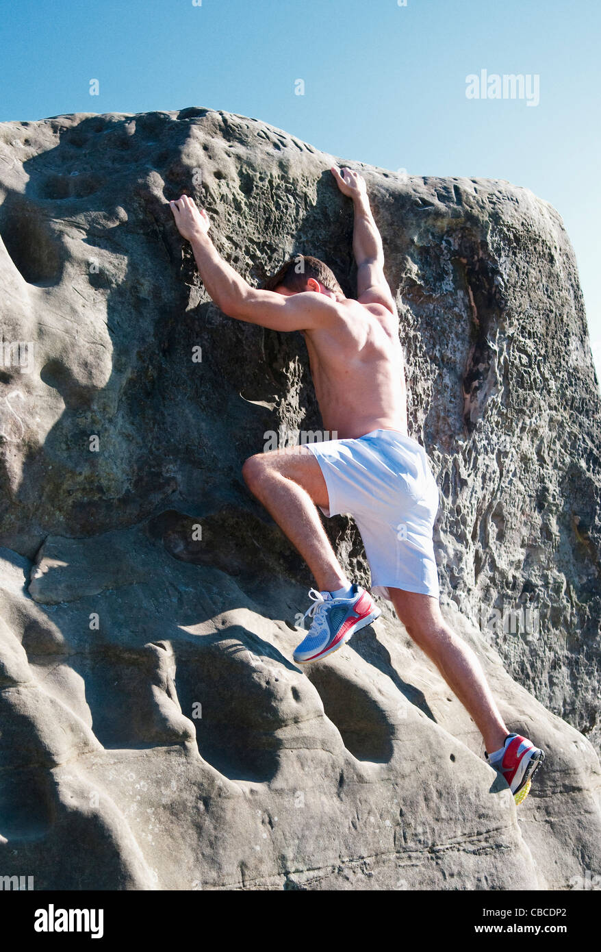 Rock climber scaling rock face Stock Photo - Alamy Rock climber scaling rock face Stock Photo - Alamy