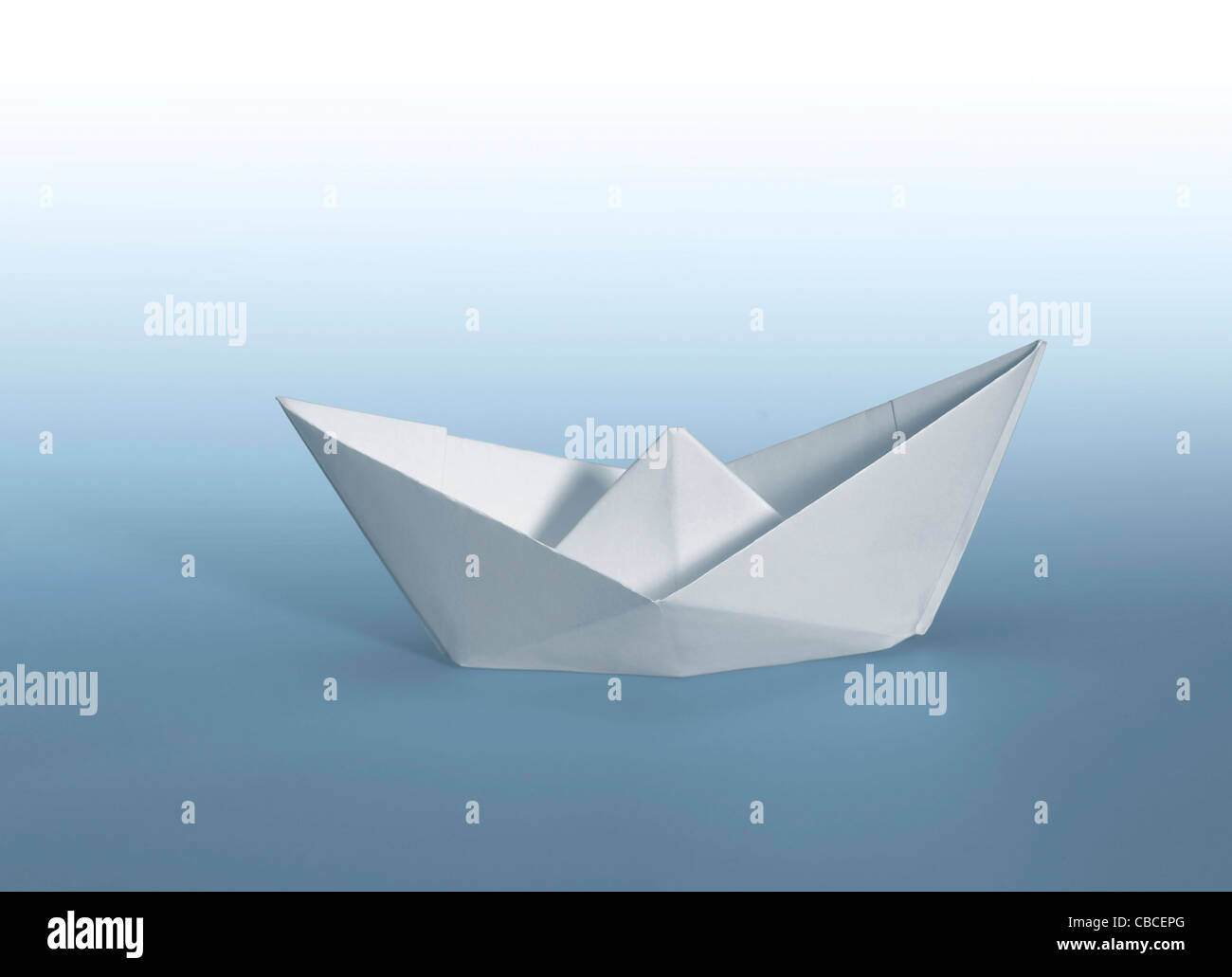 white paper ship in blue gradient back Stock Photo - Alamy