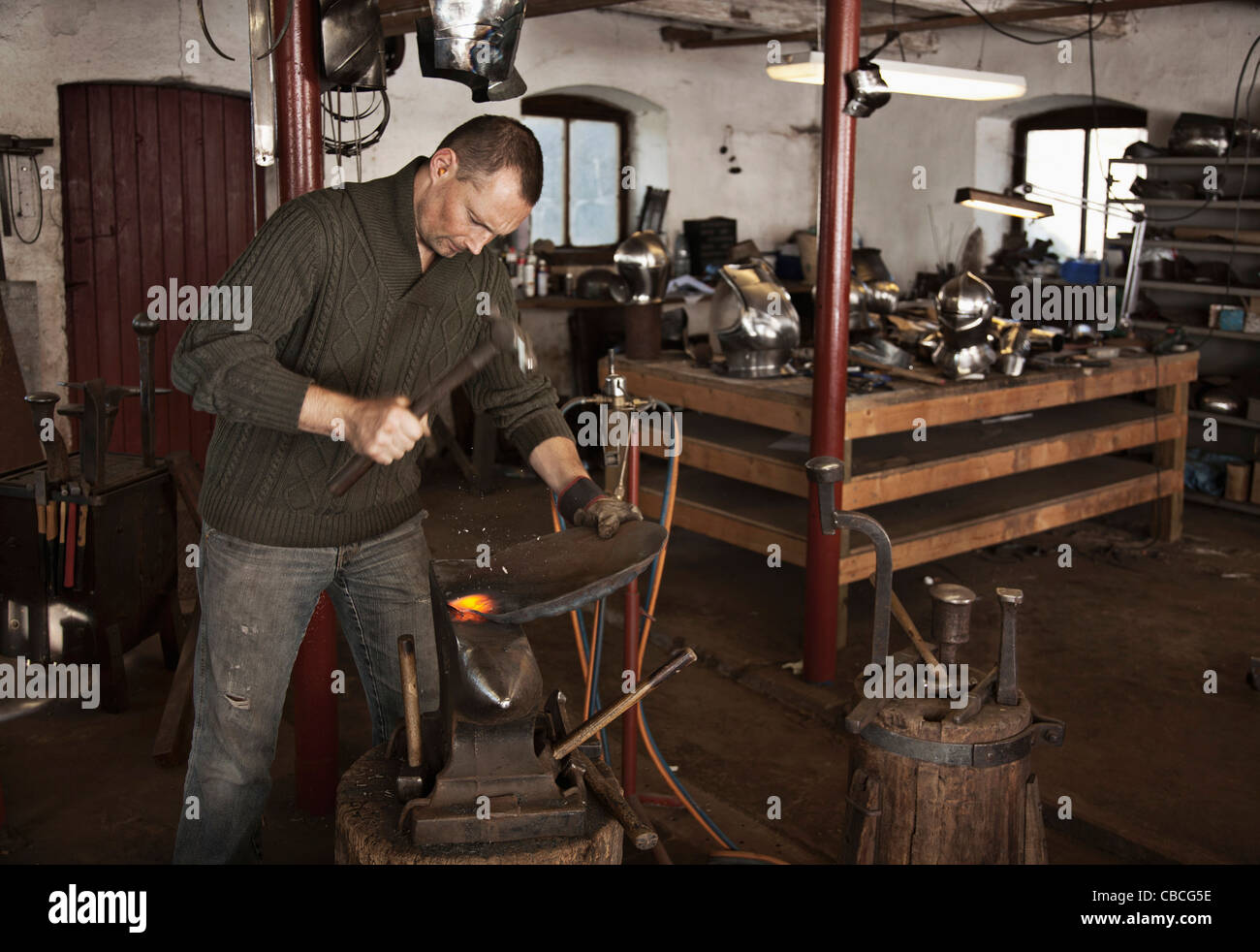 Blacksmith at work in shop Stock Photo - Alamy