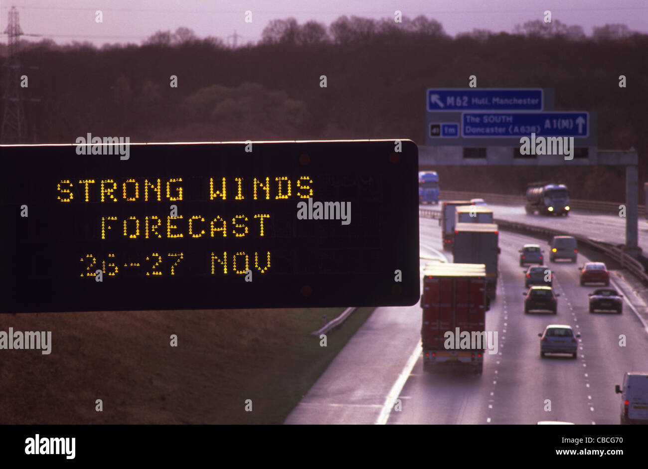 lorrys and cars on the A1/M motorway passing gantry warning sign of ...