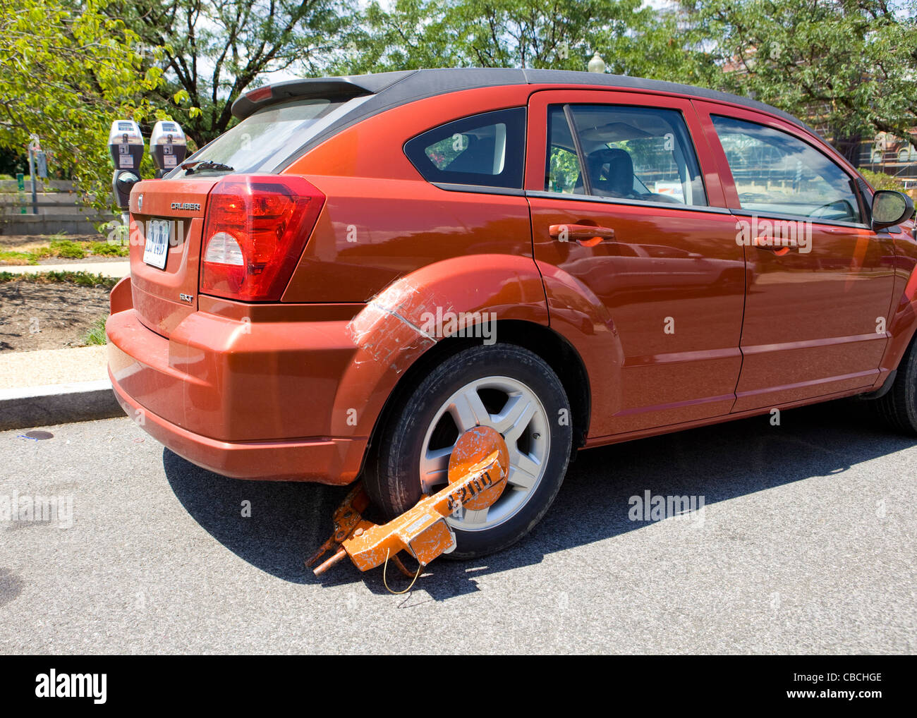A wheel clamp on the rear wheel of a car - USA Stock Photo - Alamy