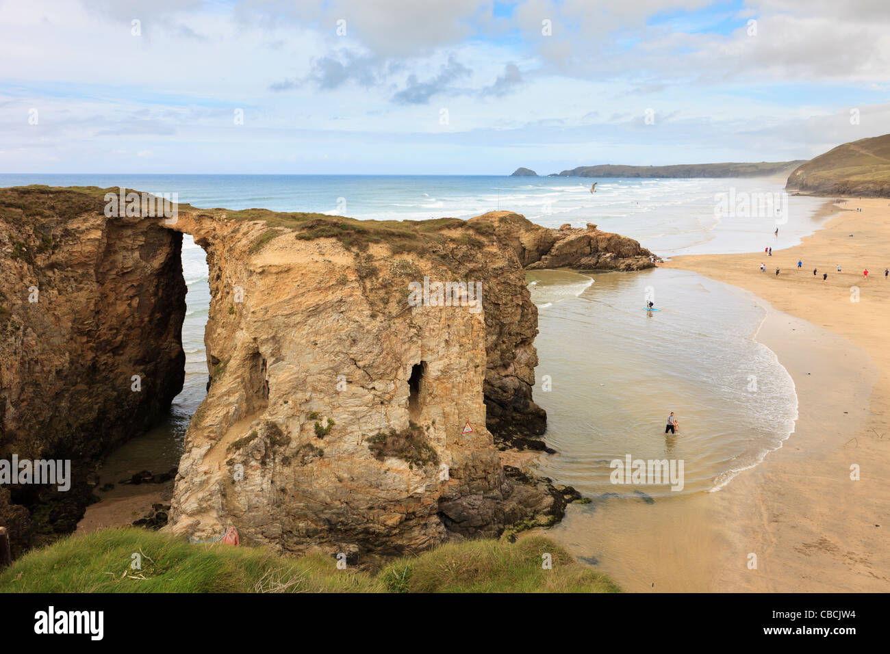 Natural rock arch at Droskyn Point with sandy Perran beach beyond ...