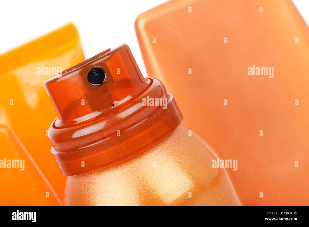 Self tanning spray and tubes, closeup on white Stock Photo - Alamy