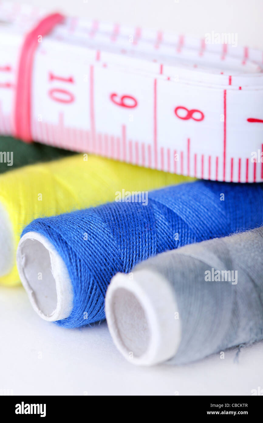 Thread and measure tape, closeup Stock Photo - Alamy