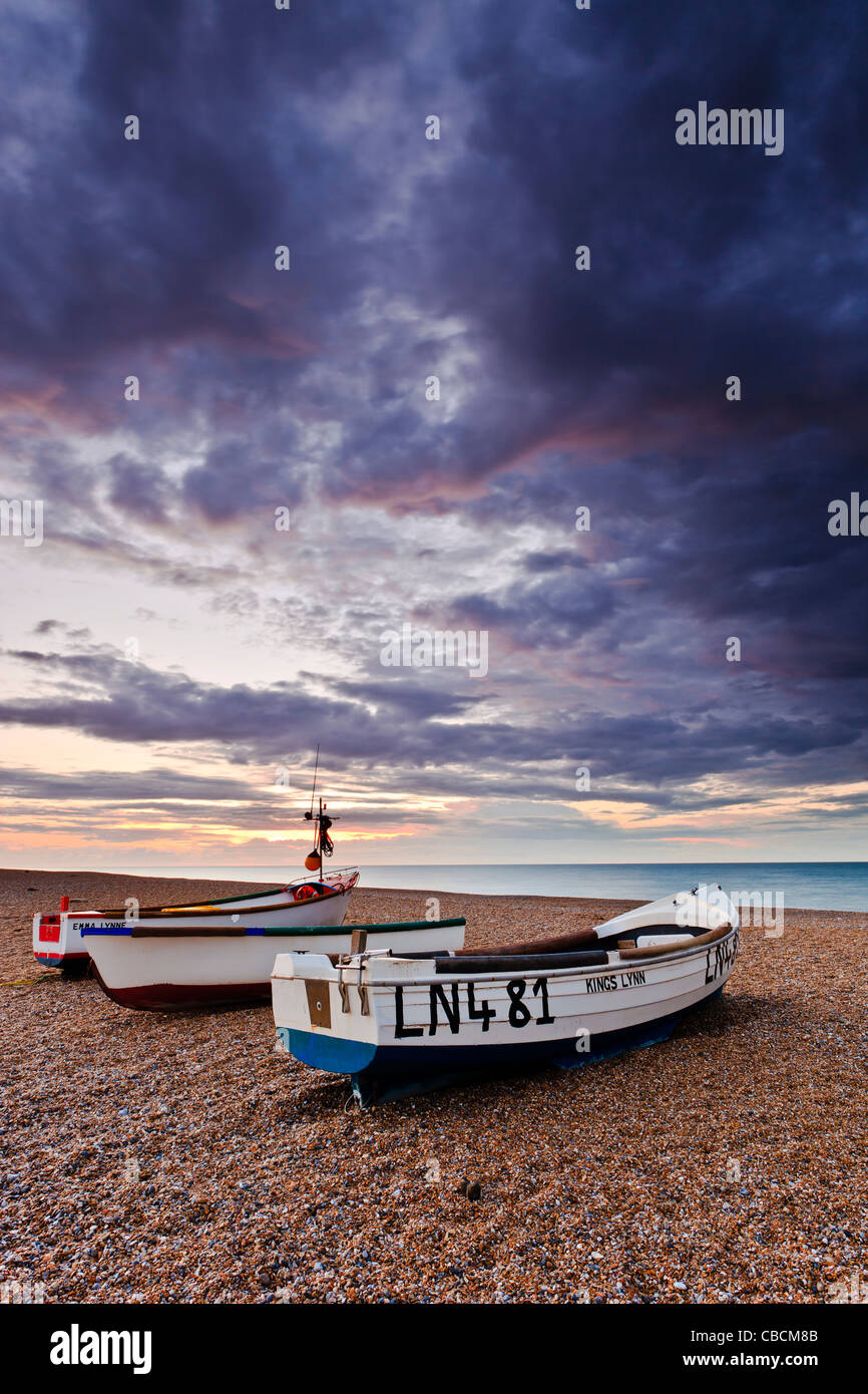 Three small fishing boats on the shingle beach of Cley Next The Sea on ...