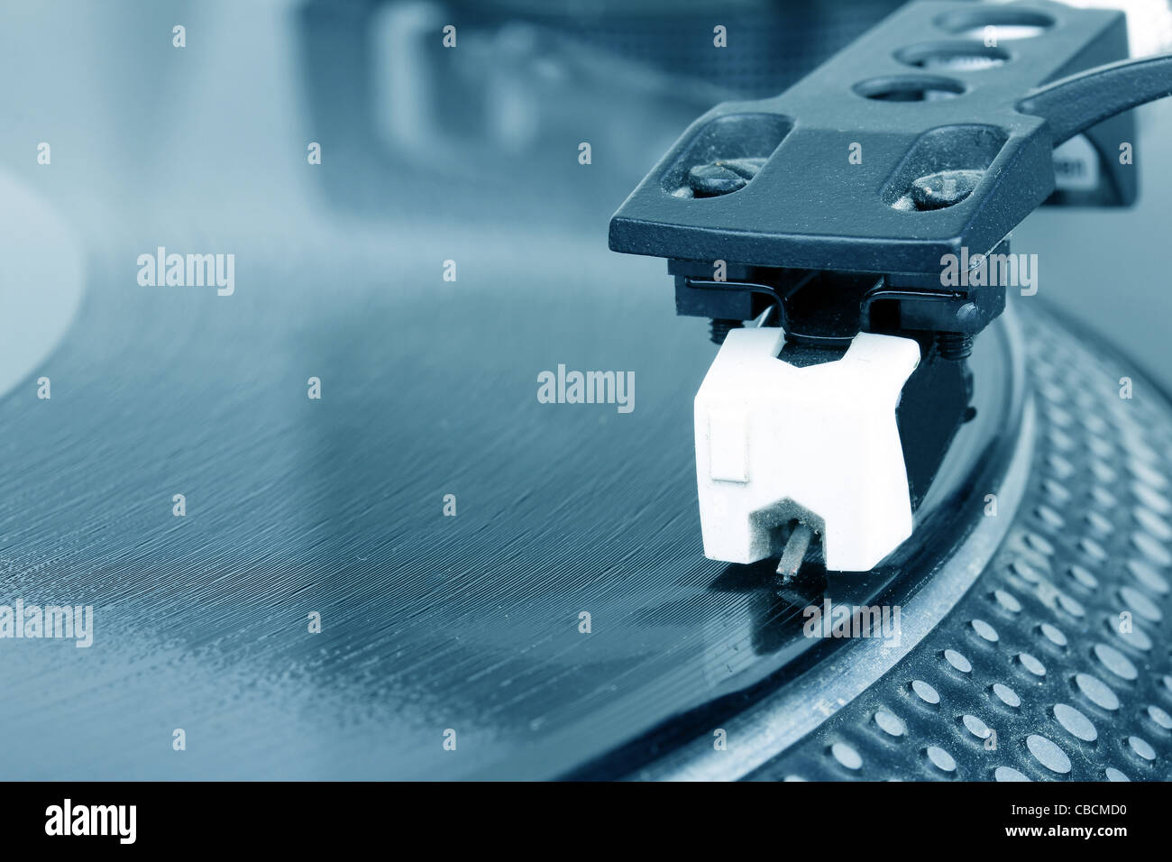 Dj needle on record, blue tones Stock Photo - Alamy
