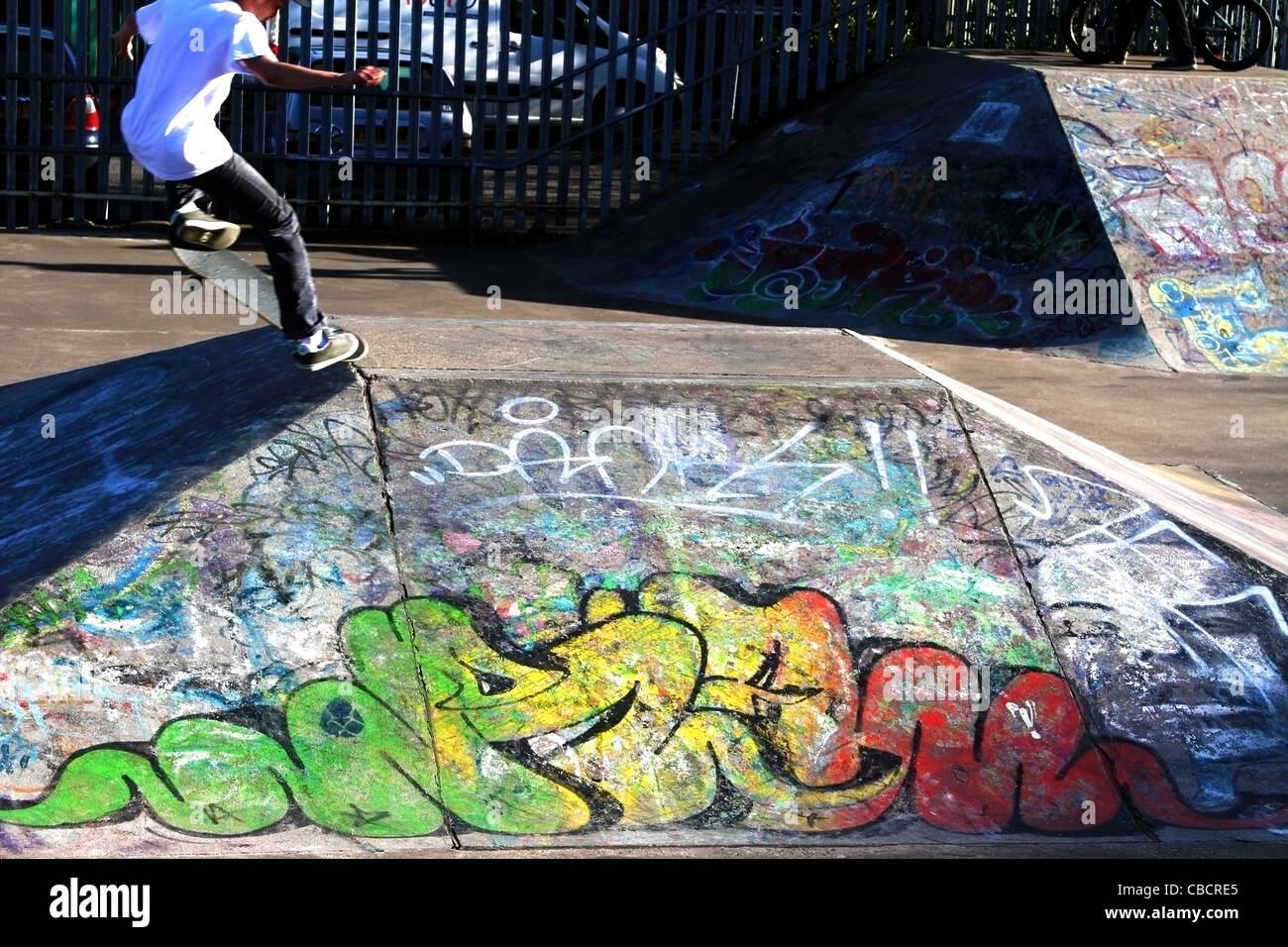 Skater skating jump on incline object up hill Stock Photo - Alamy