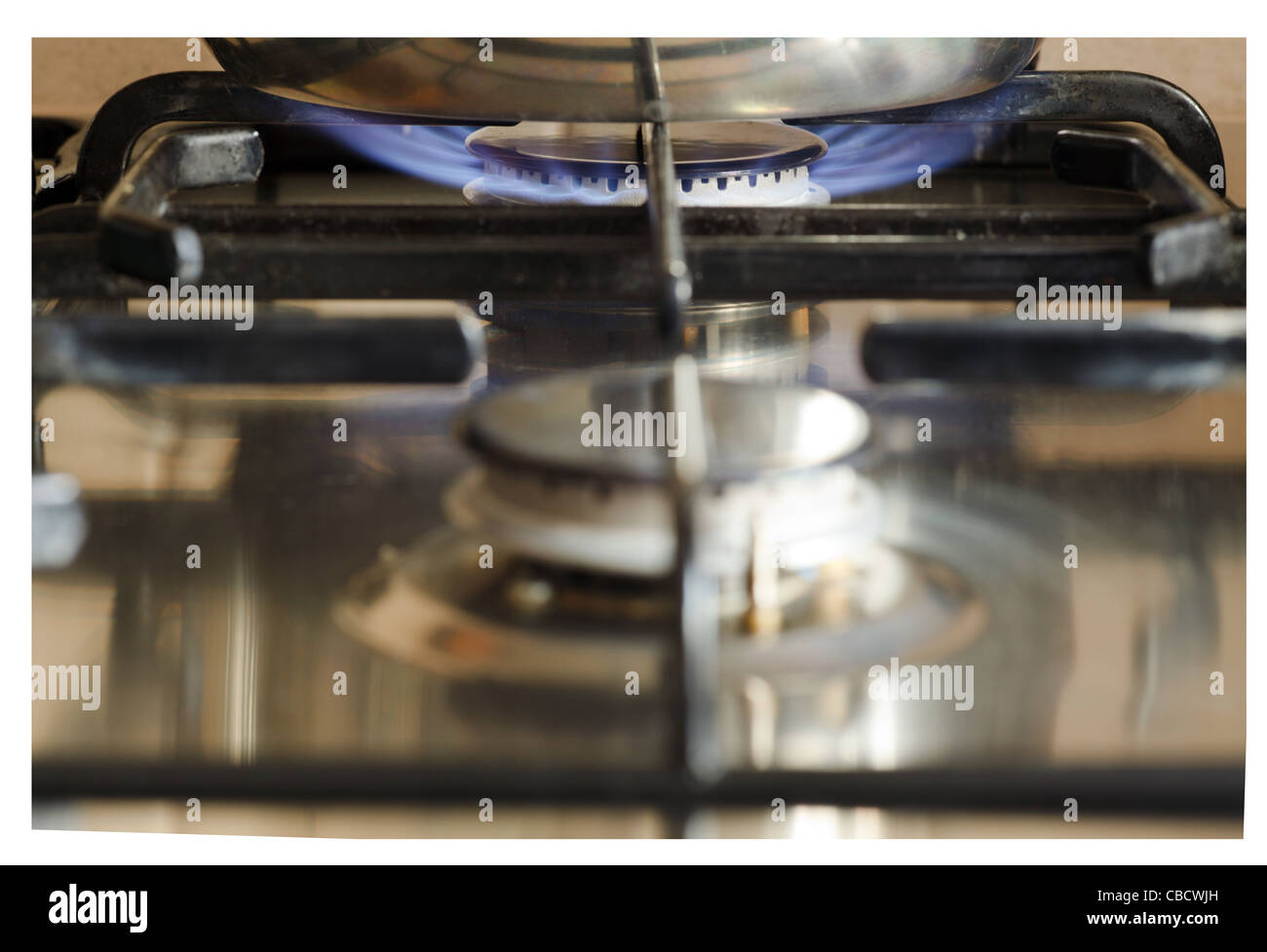 gas burner flame with reflection in kitchen Stock Photo - Alamy