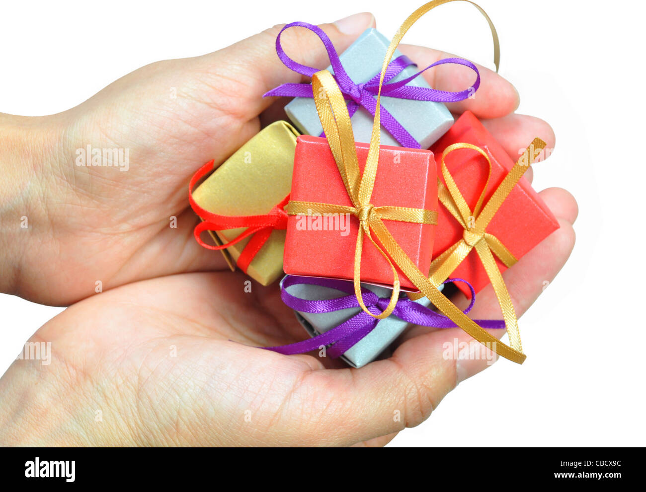 Hands holding small gift boxes Stock Photo - Alamy