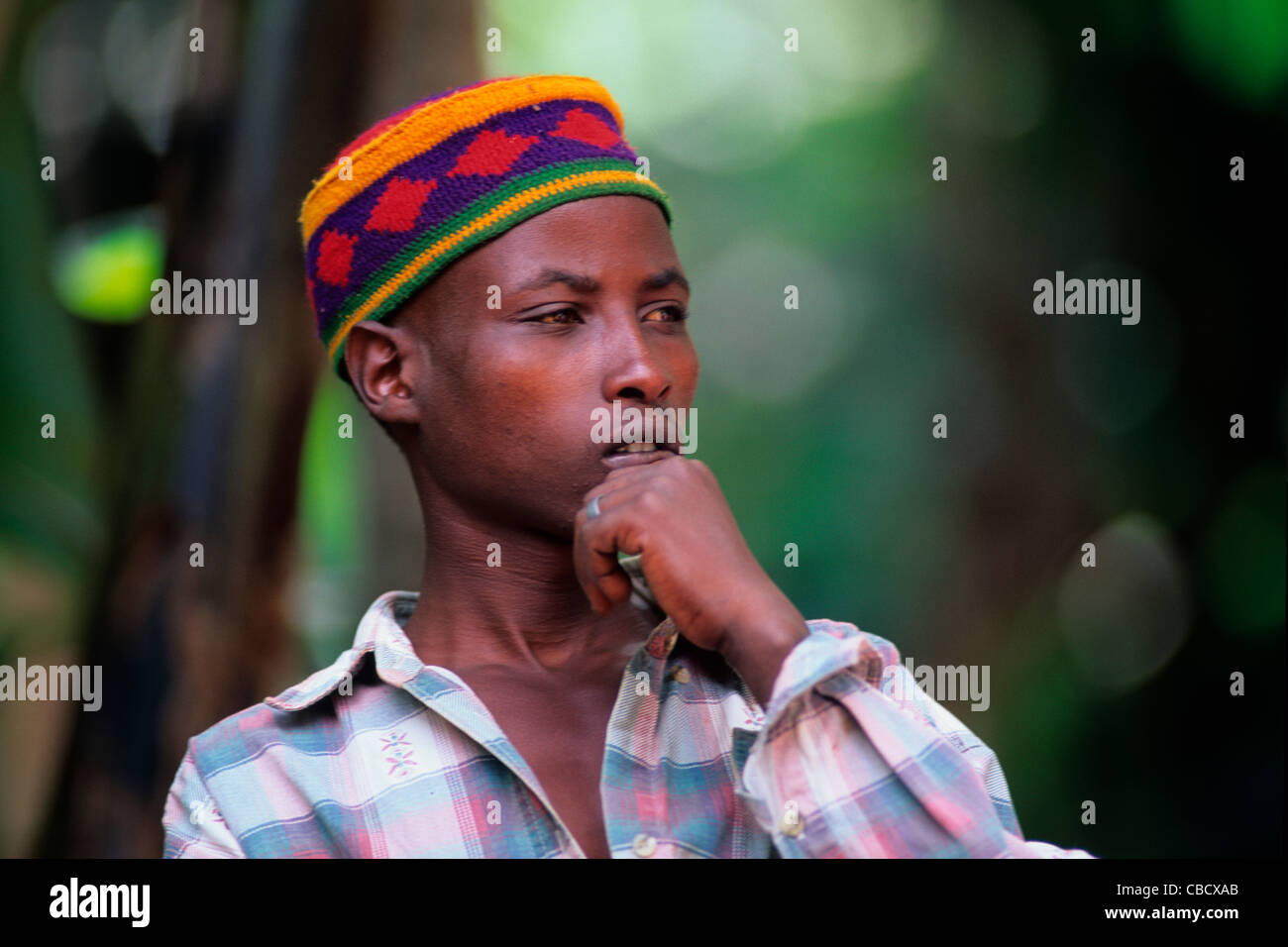 Young man with traditional hat looking skeptical, Himo in Kilimanjaro ...