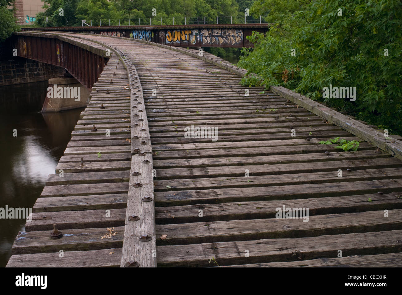 old abandoned railroad bridges converging and marked with graffiti at nicollet island in ...