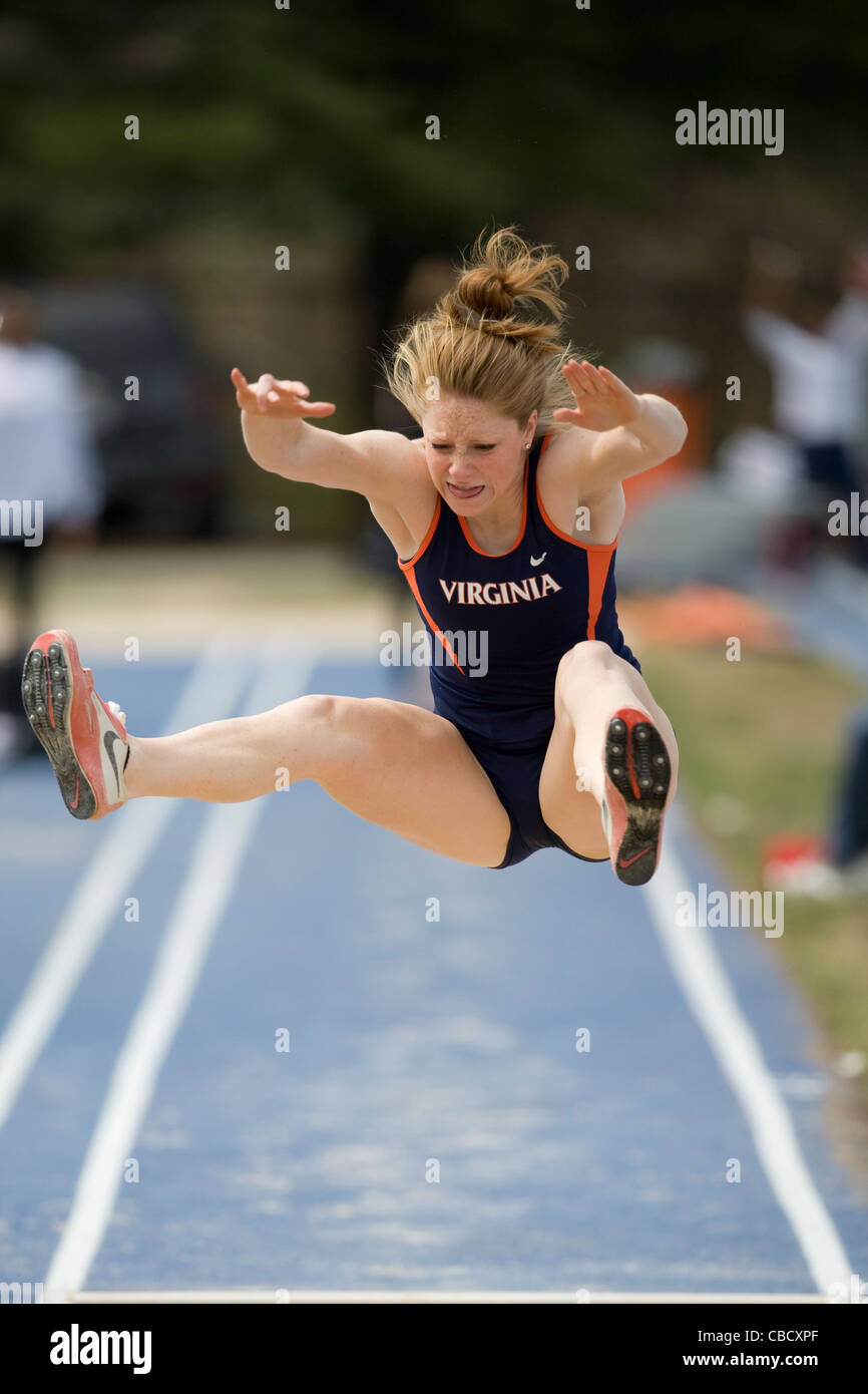 Female athlete jumping in the air on the long jump Stock Photo - Alamy