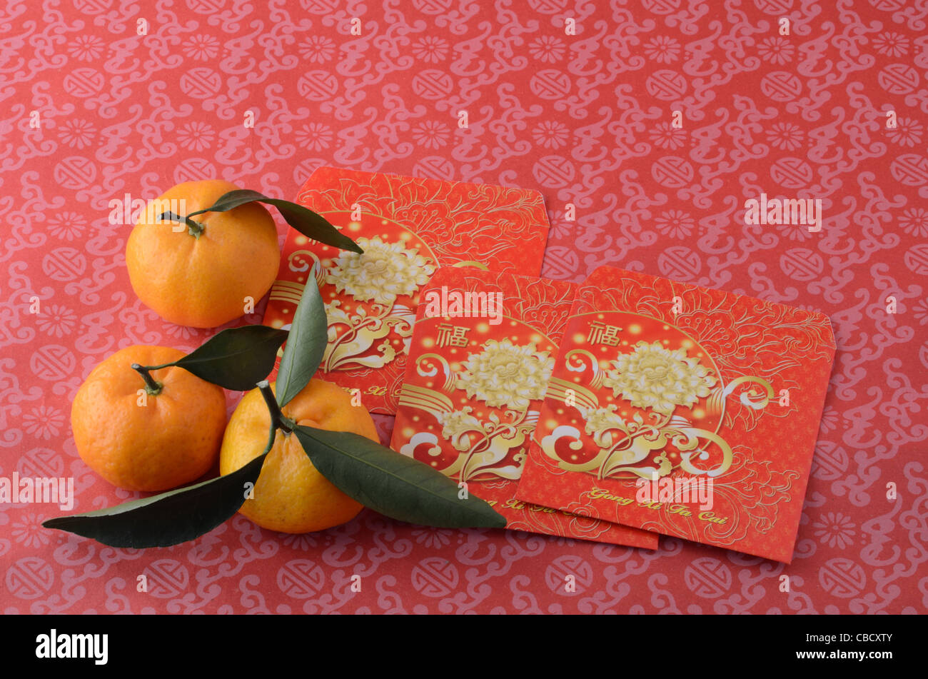 Chinese New Year celebration with tangerines and red packets Stock ...