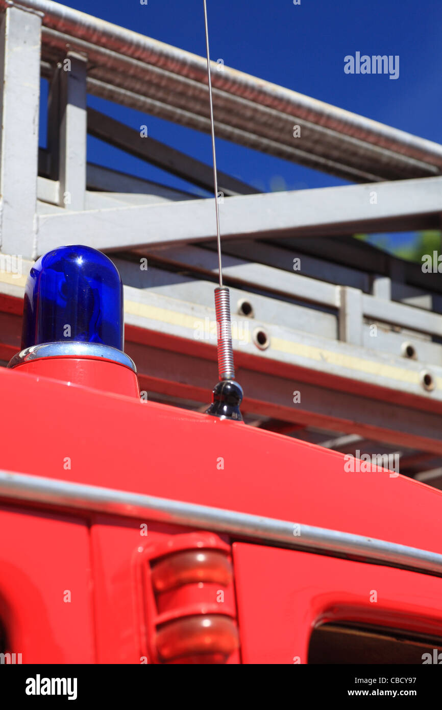 Ladder of a fire truck on the blue sky, emergency light on firetruck ...