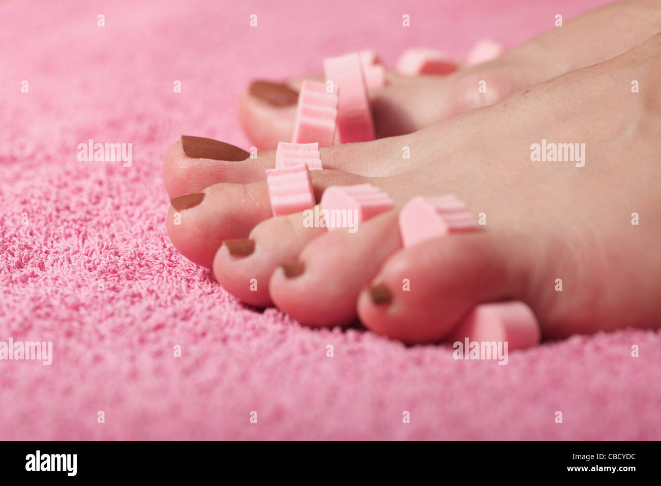 foot pedicure applying pink background Stock Photo - Alamy