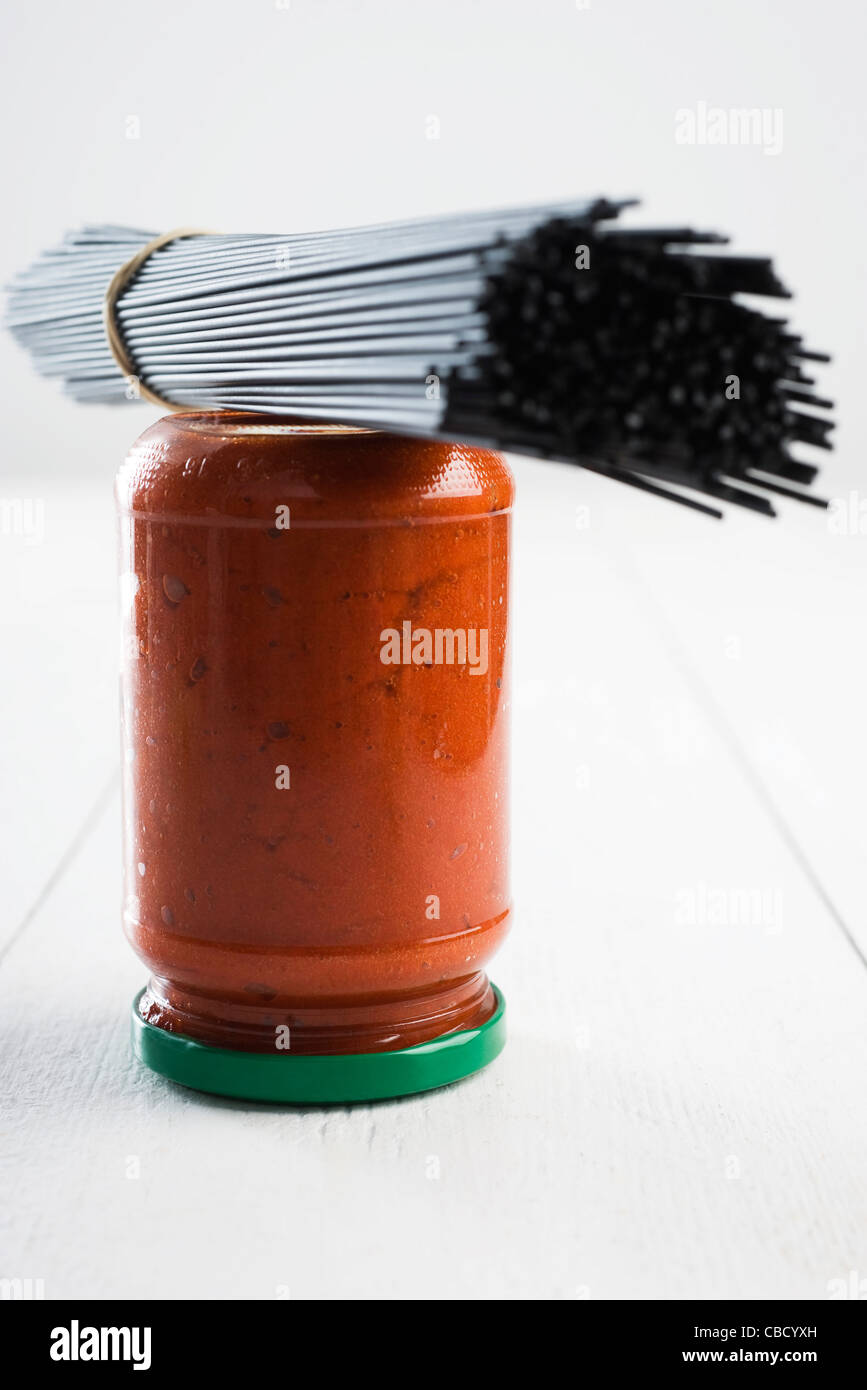 Red bell pepper coulis and squid ink pasta Stock Photo - Alamy