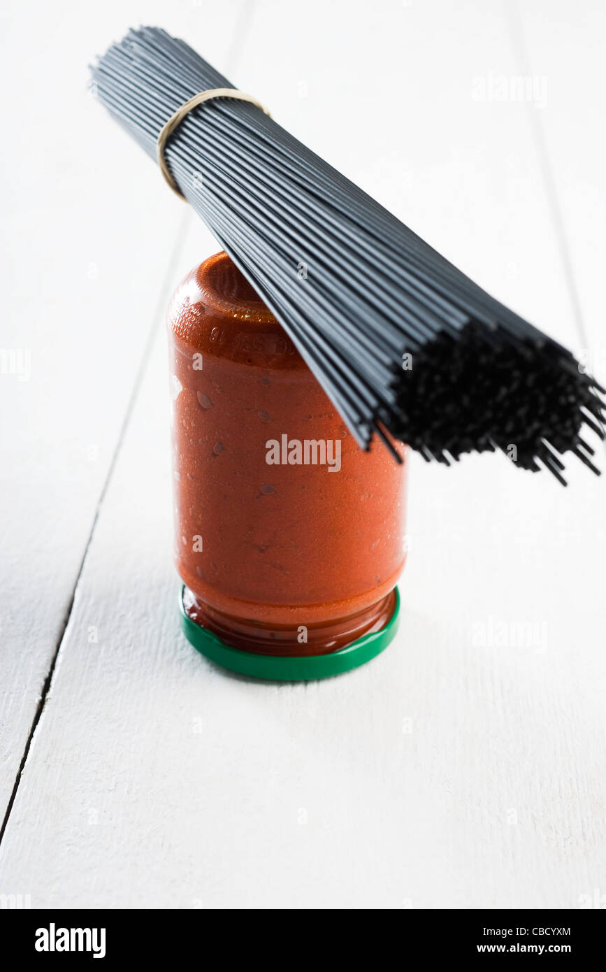 Red bell pepper coulis and squid ink pasta Stock Photo - Alamy