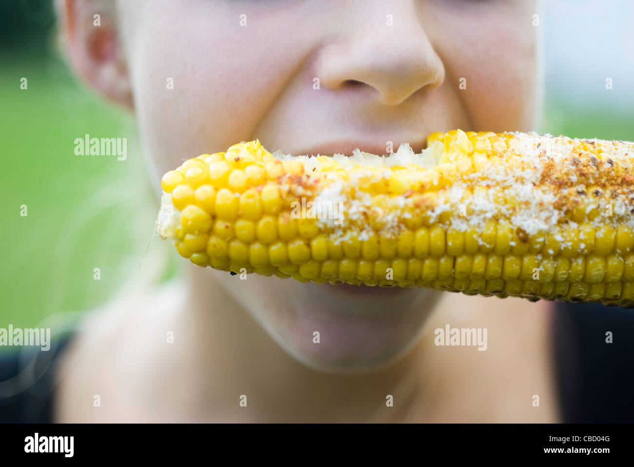 Person eating corn on the cob Stock Photo - Alamy