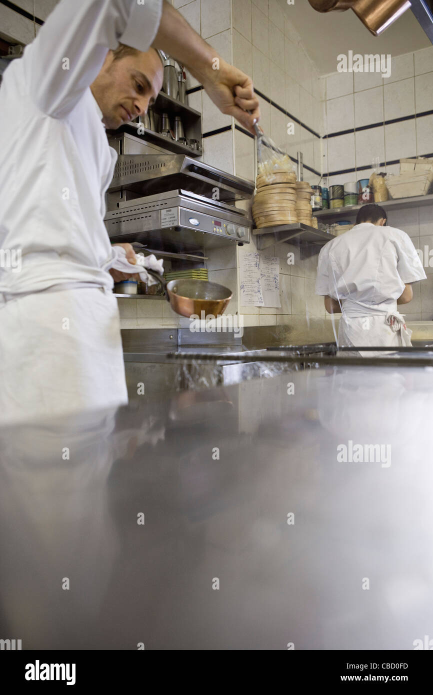 Chefs working in commercial kitchen Stock Photo - Alamy