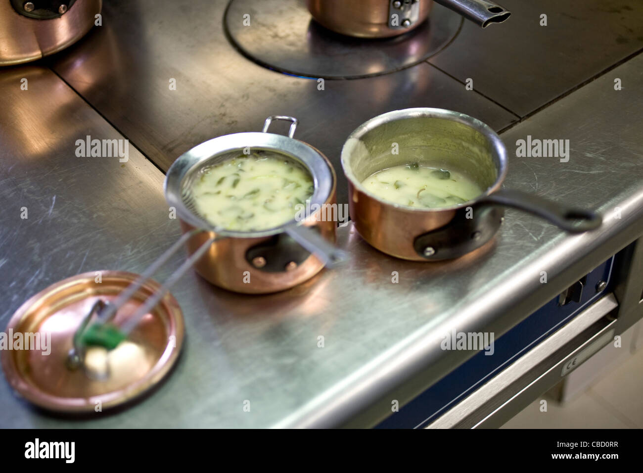 Food being prepared in copper saucepans Stock Photo - Alamy