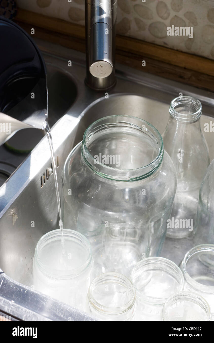 Cleaning glass jars in sink Stock Photo - Alamy