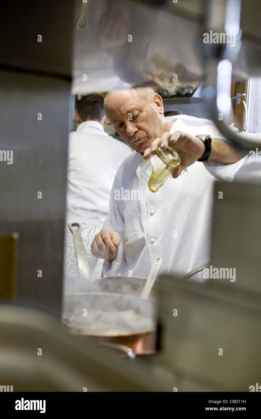 Chef cooking in commercial kitchen Stock Photo - Alamy