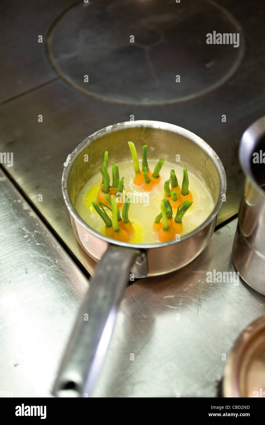Carrots cooking in pan Stock Photo - Alamy